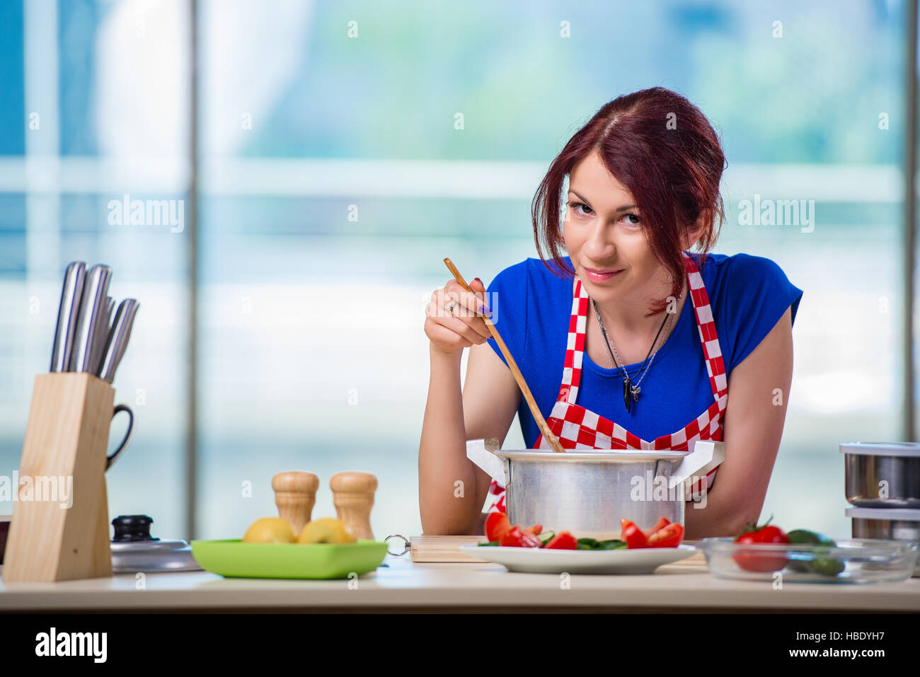 Woman preparing soup in the kitchen Stock Photo - Alamy