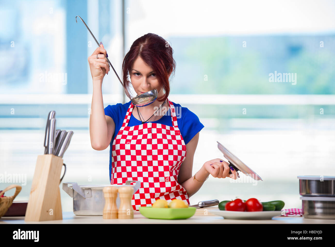 Woman preparing soup in the kitchen Stock Photo - Alamy