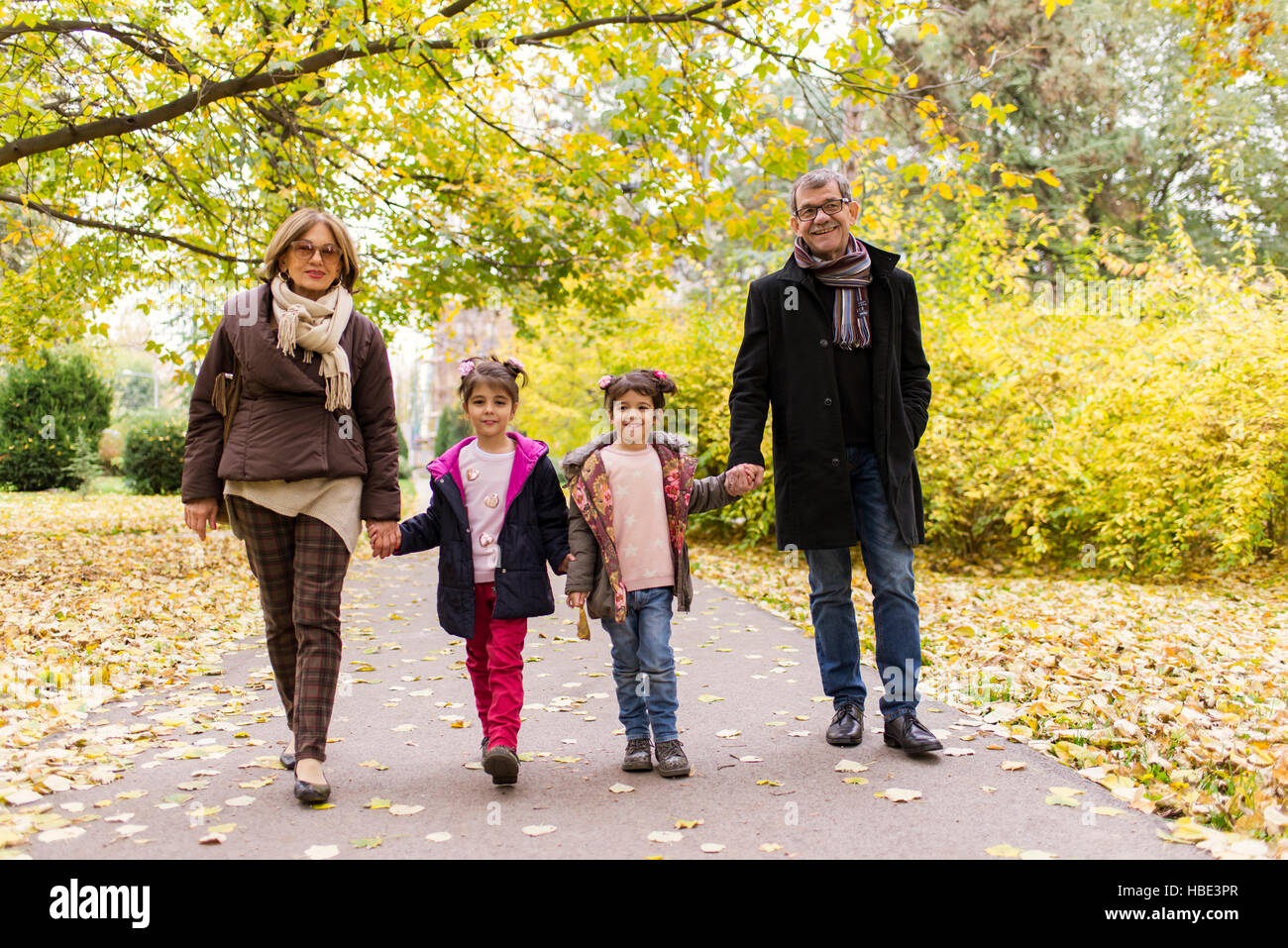 Happy grandparents walking with grandchildren in the autumn park Stock ...