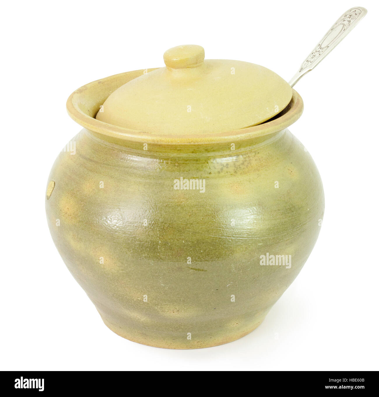 Old ceramic pot with a spoon Stock Photo - Alamy