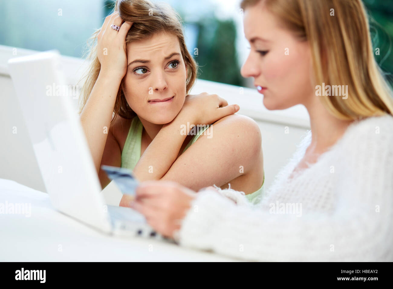 Two girls overspent on accounts Stock Photo - Alamy