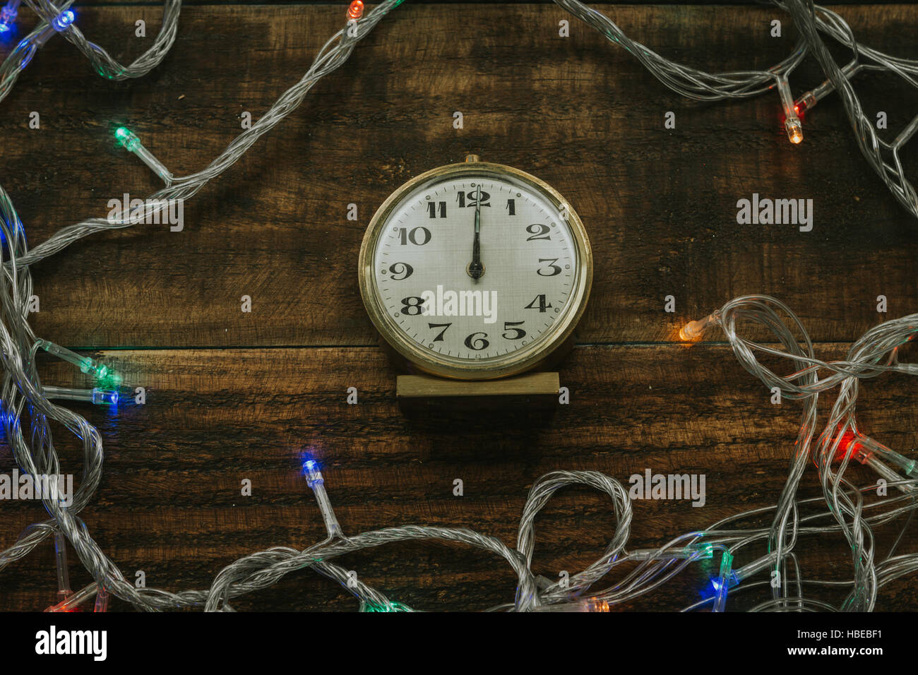 Old golden alarm clock with lights on a wooden background Stock Photo ...