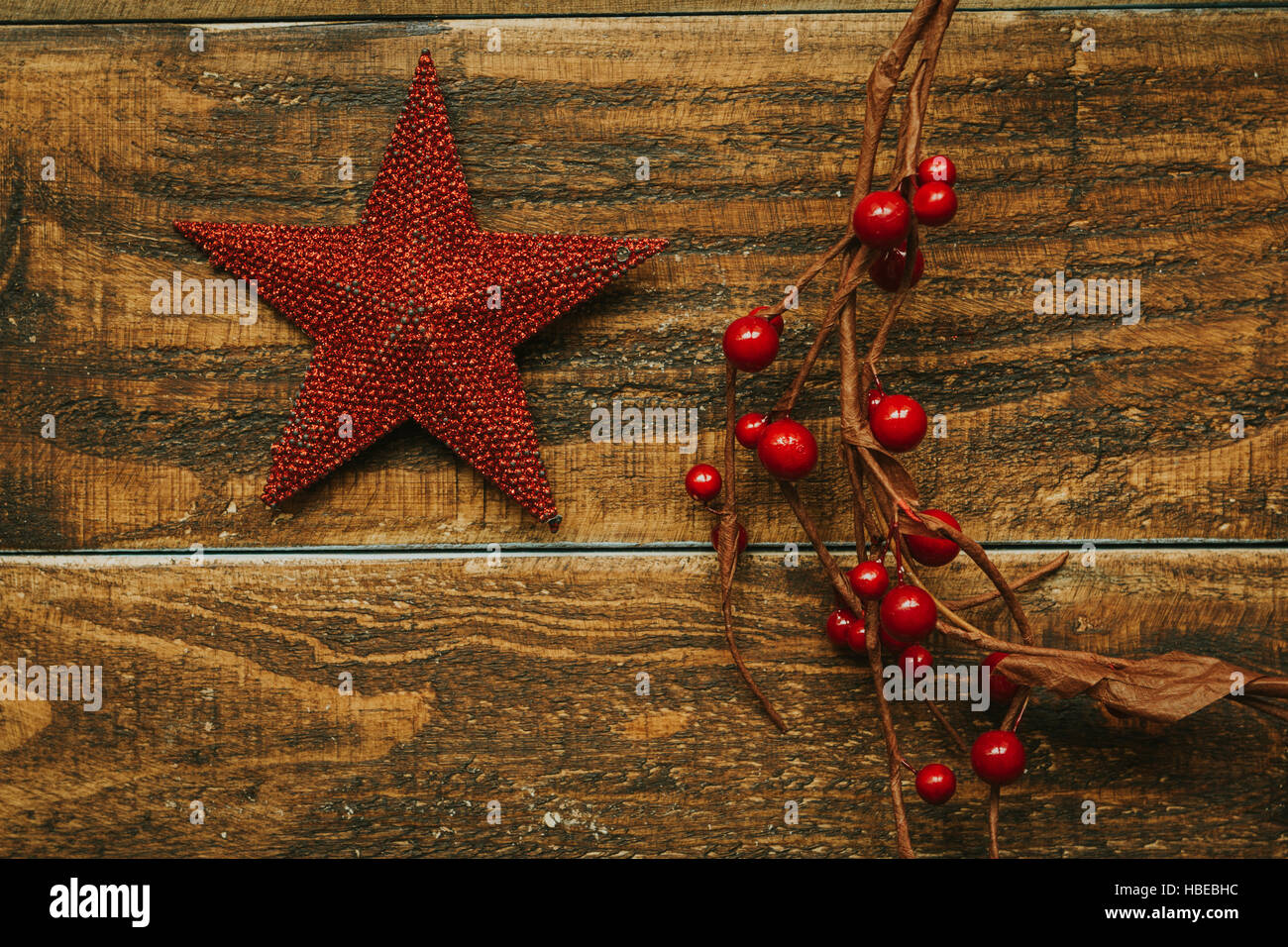 Red Christmas star on a rustic wooden background Stock Photo - Alamy