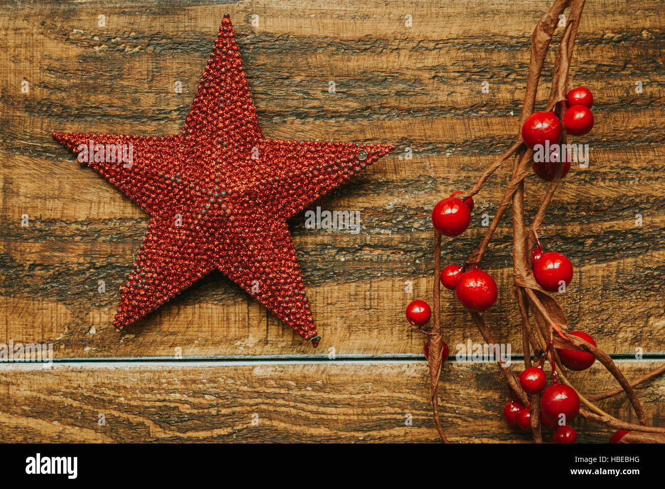 Red Christmas star on a rustic wooden background Stock Photo - Alamy