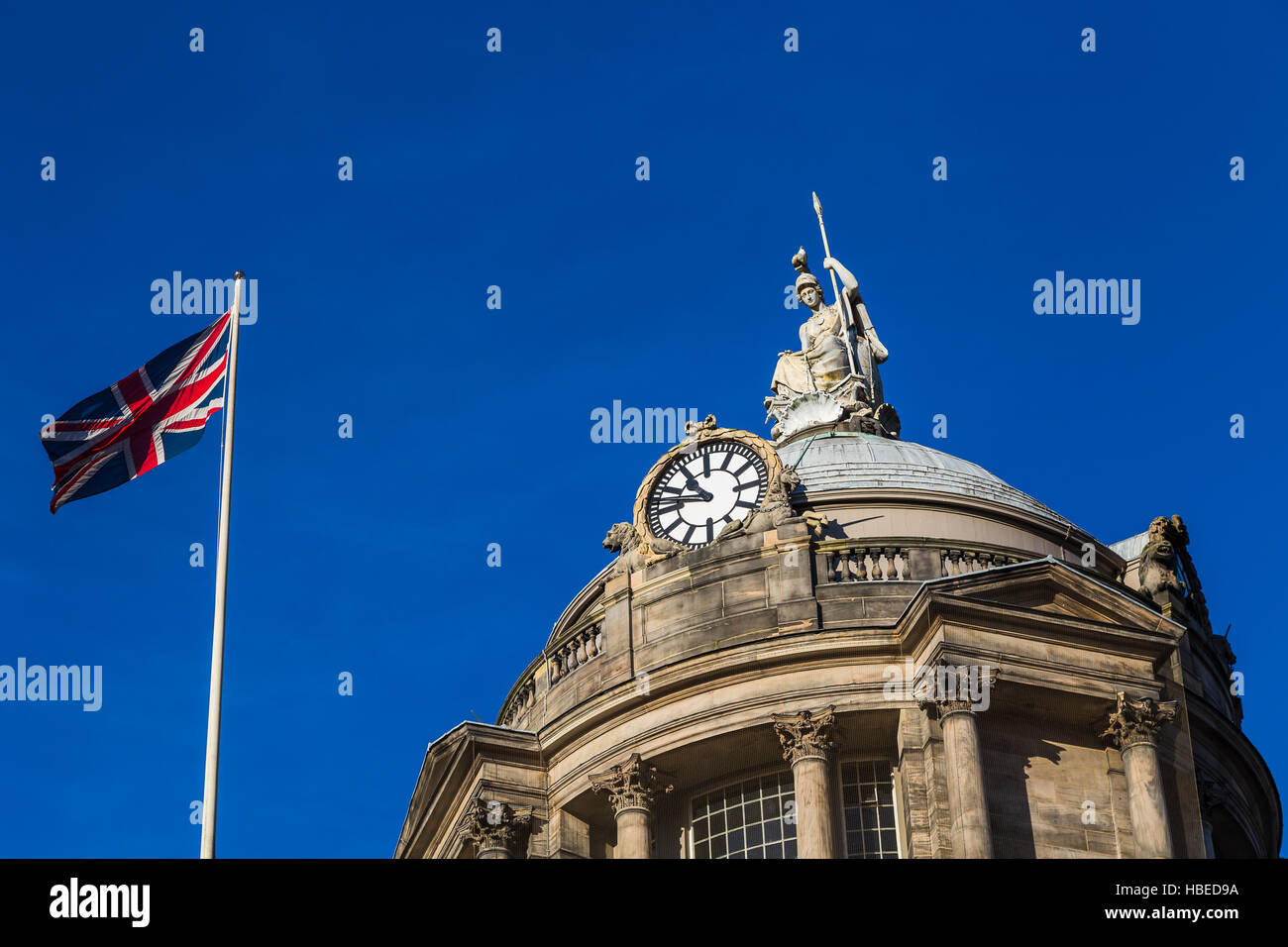 A Union Jack gently flaps in the wind next to the dome of Liverpool's ...