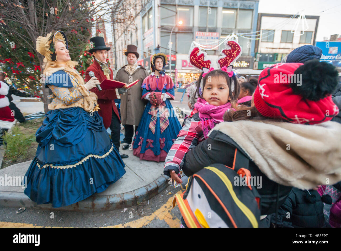 Carolers in Victorian costumes entertain during the Christmas tree ...