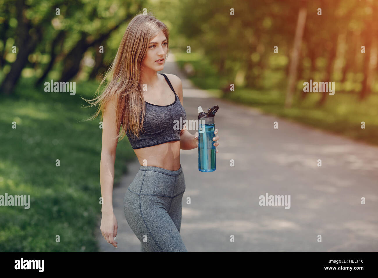 athletic girl running in the Park and doing exercises Jogging Stock ...