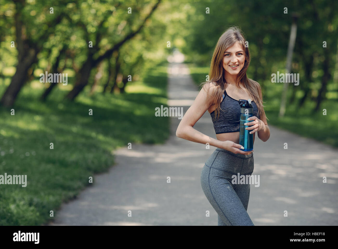 athletic girl running in the Park and doing exercises Jogging Stock ...