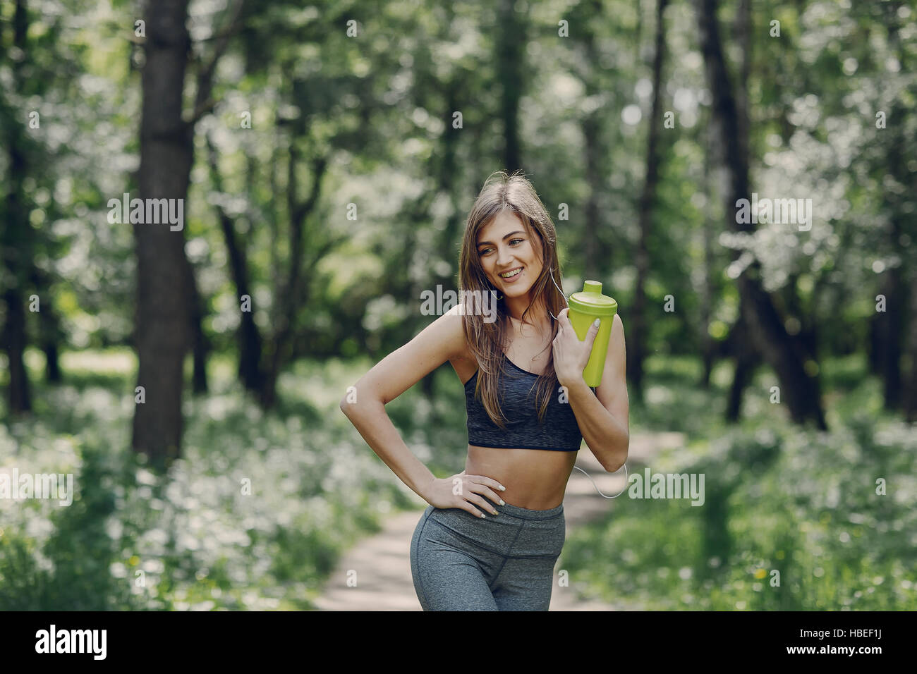 athletic girl running in the Park and doing exercises Jogging Stock ...