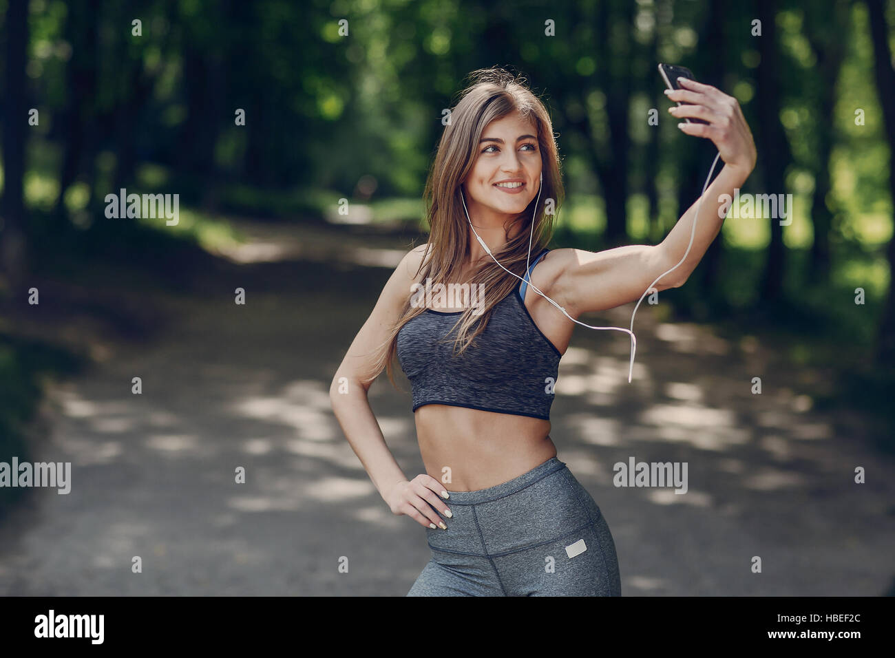 athletic girl running in the Park and doing exercises Jogging Stock ...