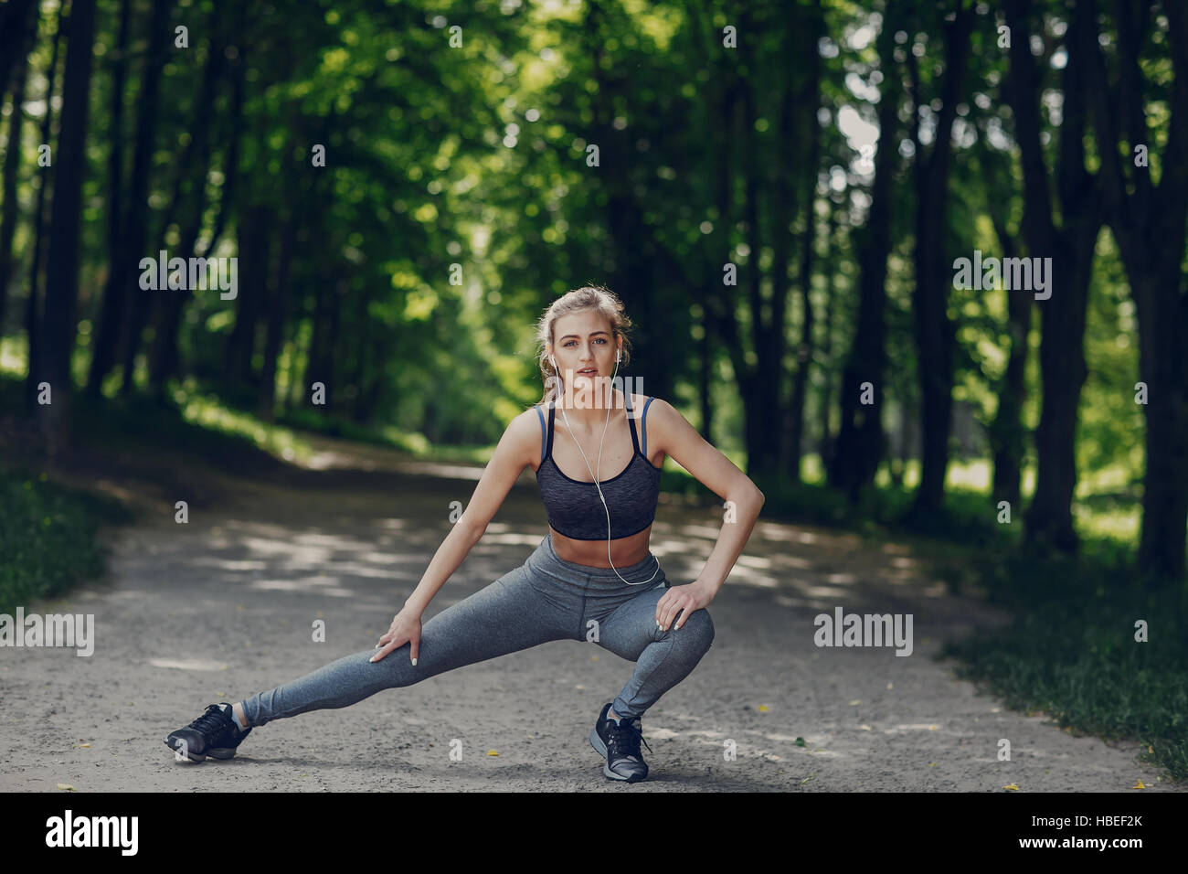 athletic girl running in the Park and doing exercises Jogging Stock ...