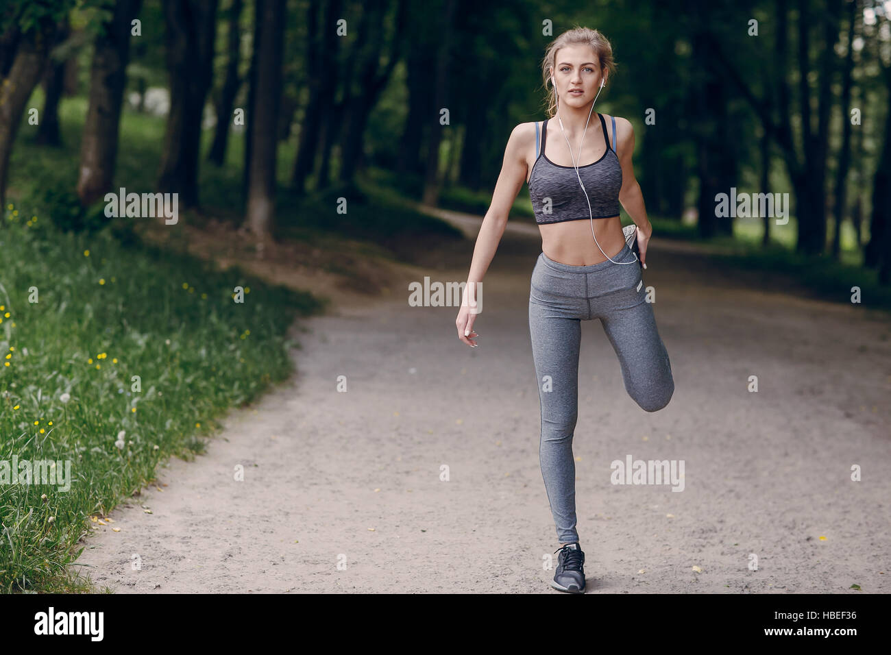 athletic girl running in the Park and doing exercises Jogging Stock ...