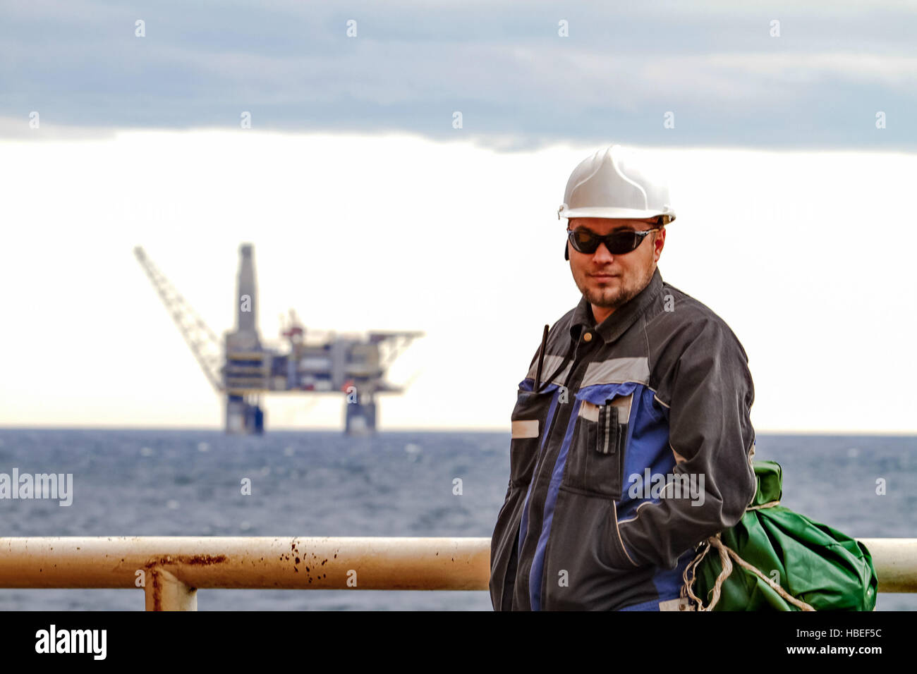 Oilman shift workers on the deck of the ship on the background offshore ...