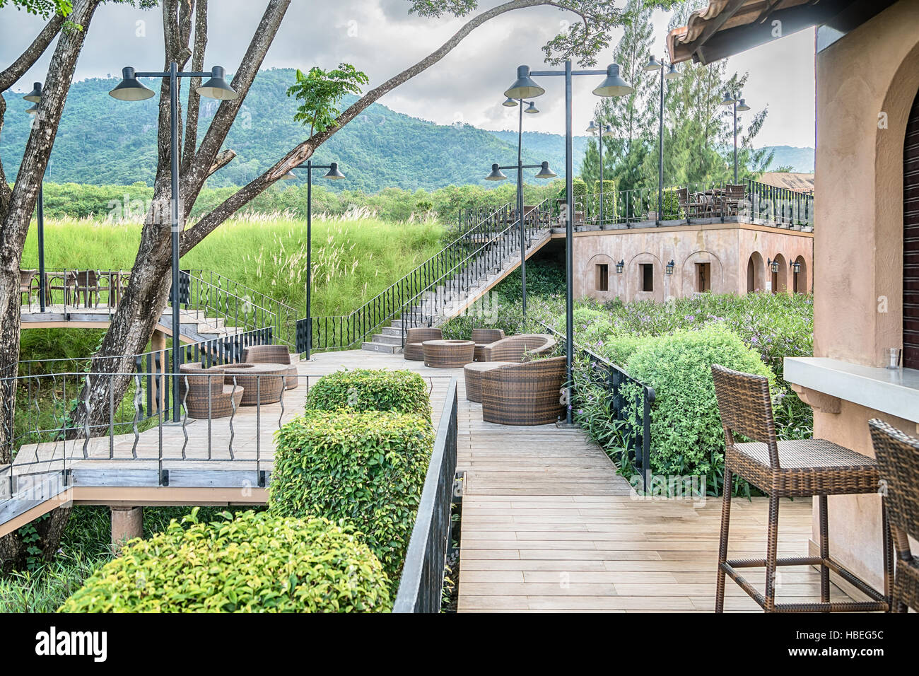 The wood table on natural outdoor of a restaurant with tree and cloudy ...