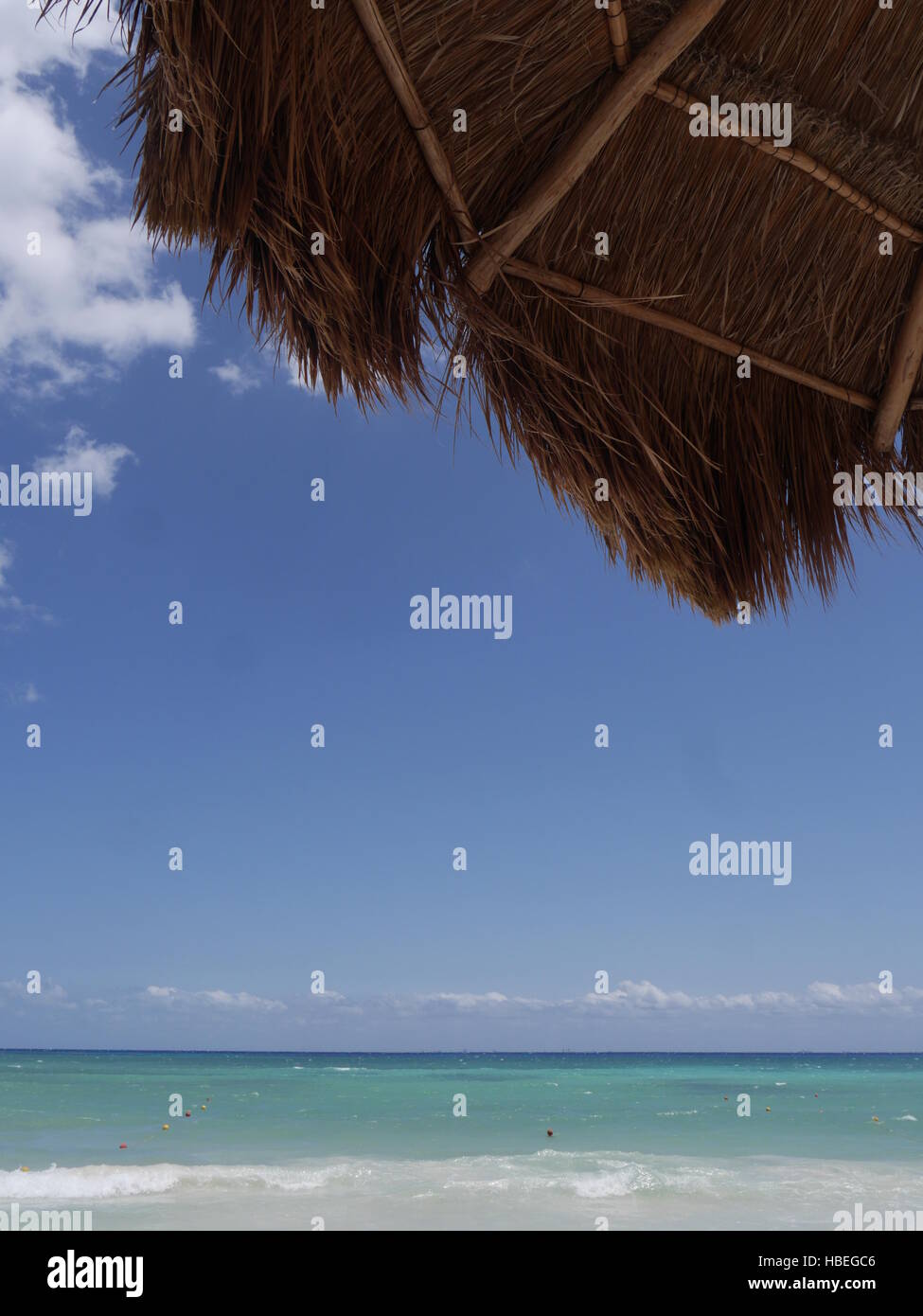 caribbean straw parasol Stock Photo - Alamy
