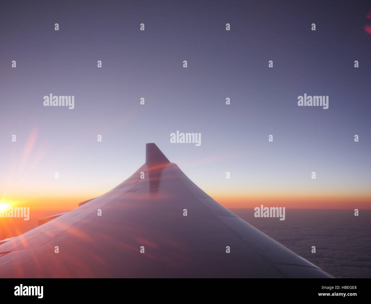 Airplane wing at sunset Stock Photo - Alamy