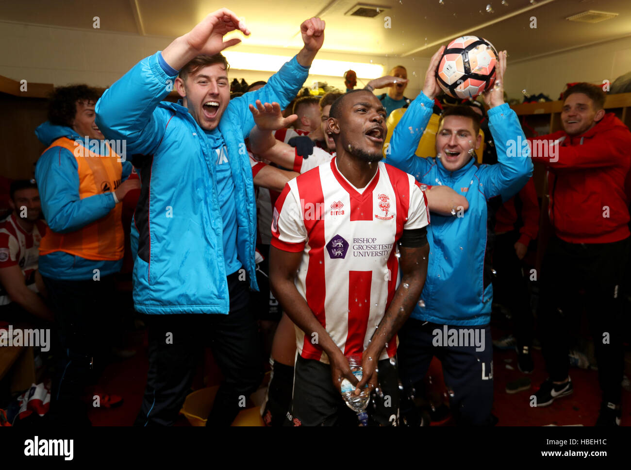 Lincoln City's Theo Robinson celebrates with teammates in the dressing ...