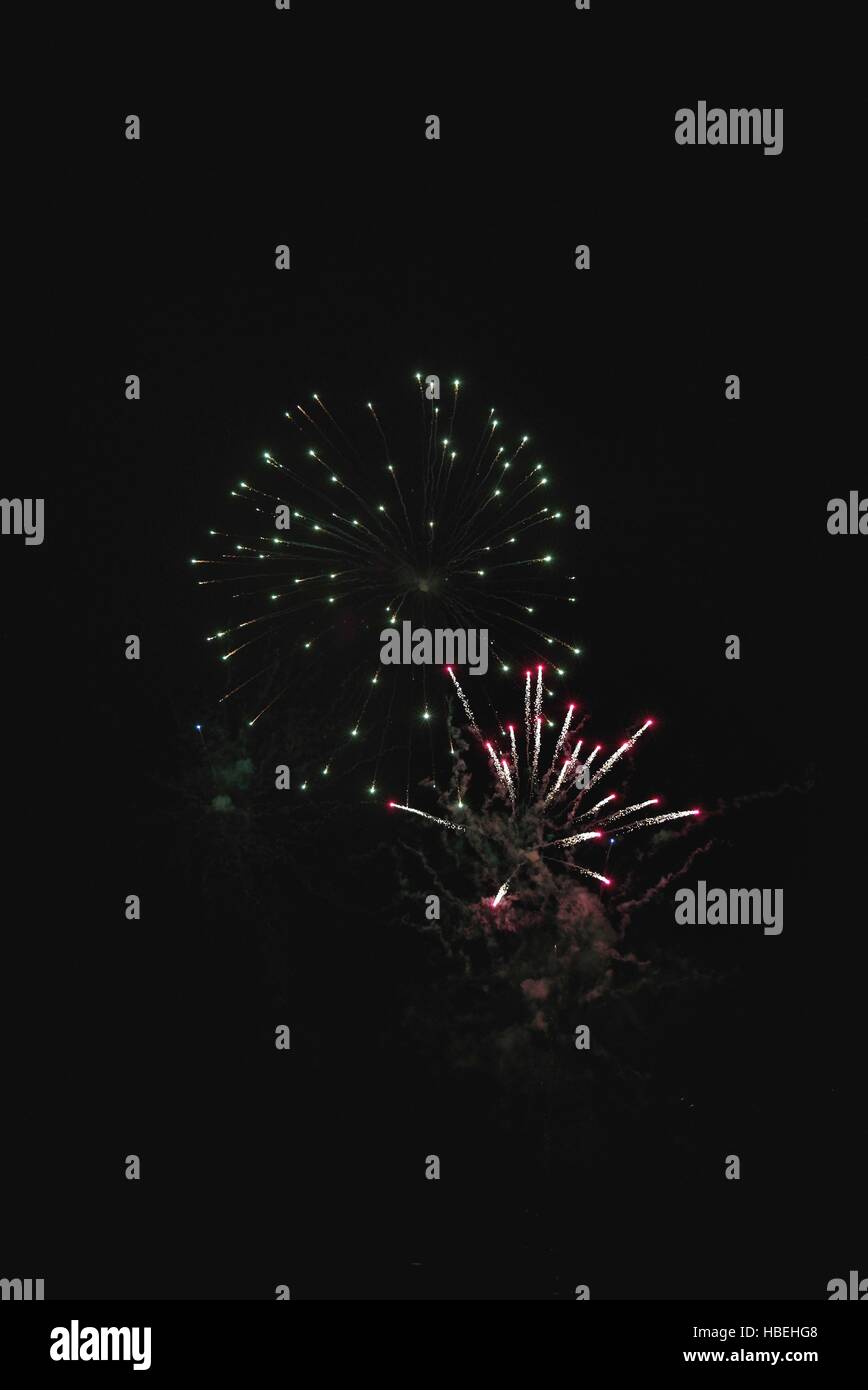 Shiny natural fireworks on dark black sky background with a little ...
