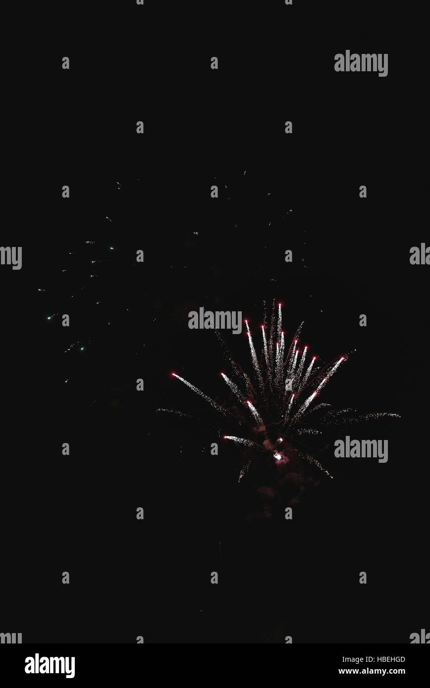 Shiny natural fireworks on dark black sky background with a little ...