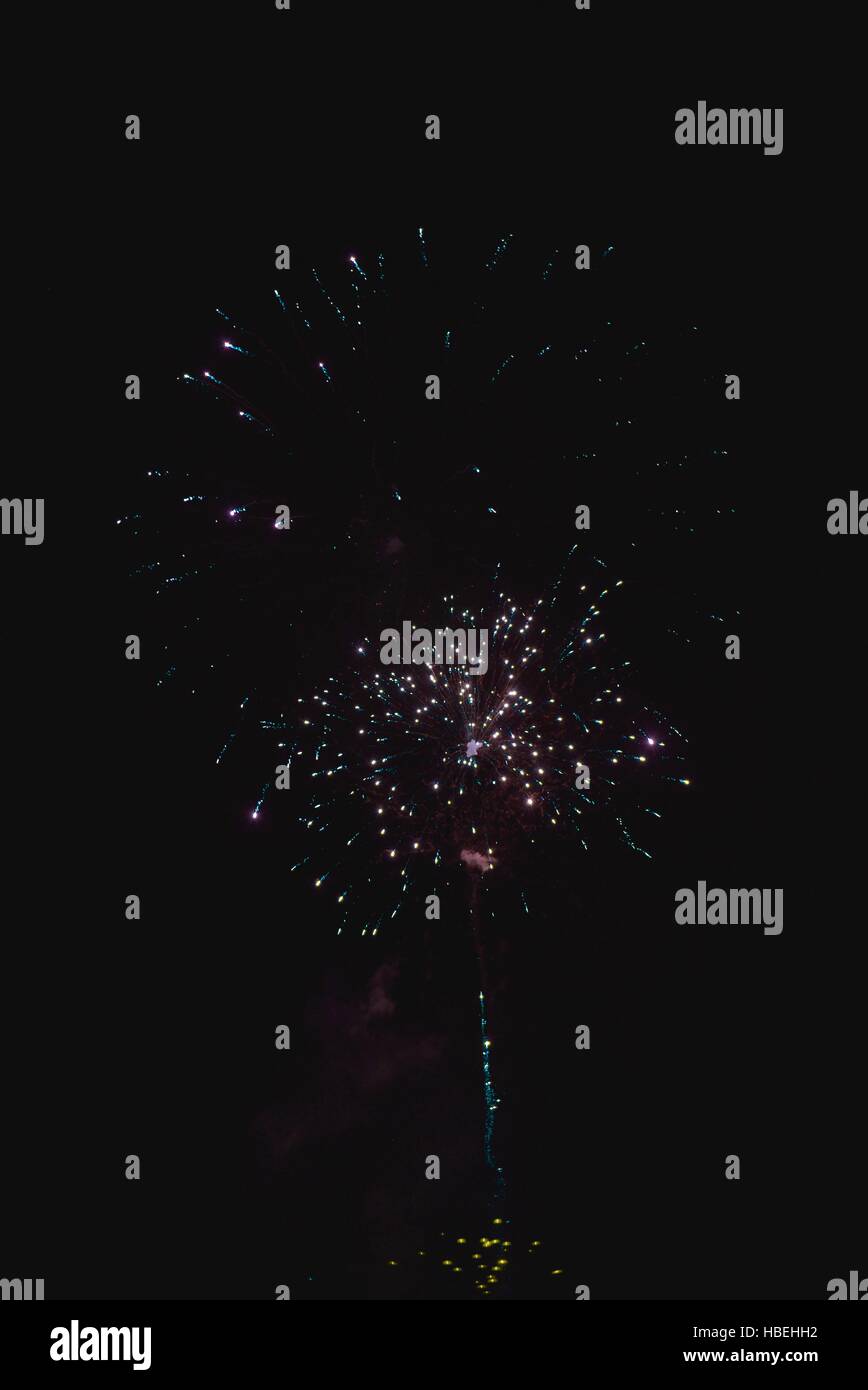 Shiny natural fireworks on dark black sky background with a little ...