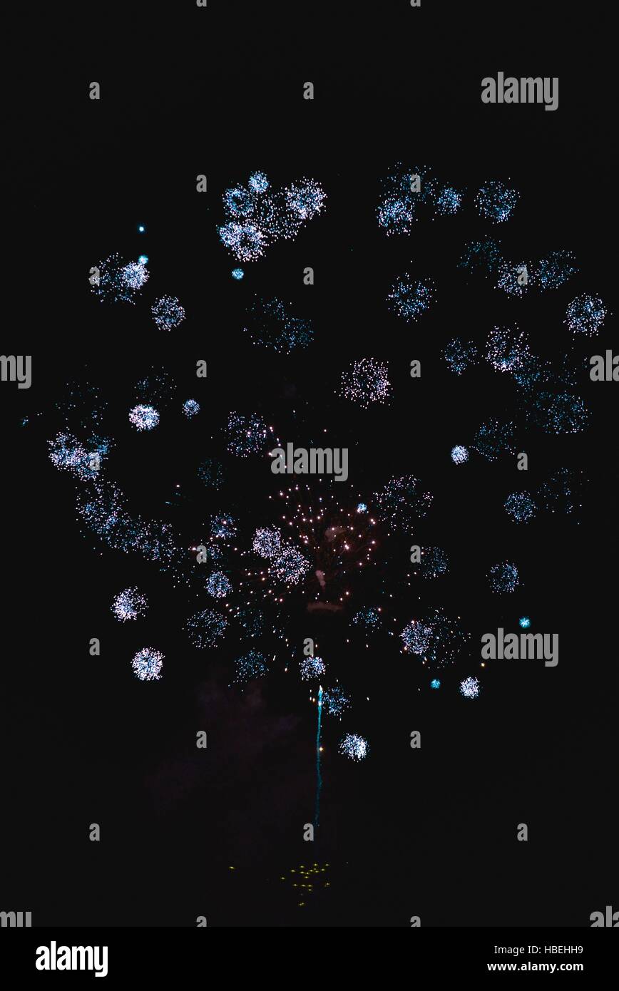 Shiny natural fireworks on dark black sky background with a little ...