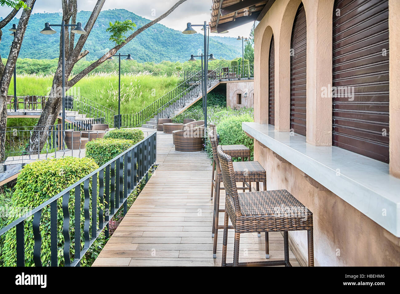 The wood table on natural outdoor of a restaurant with tree and cloudy ...