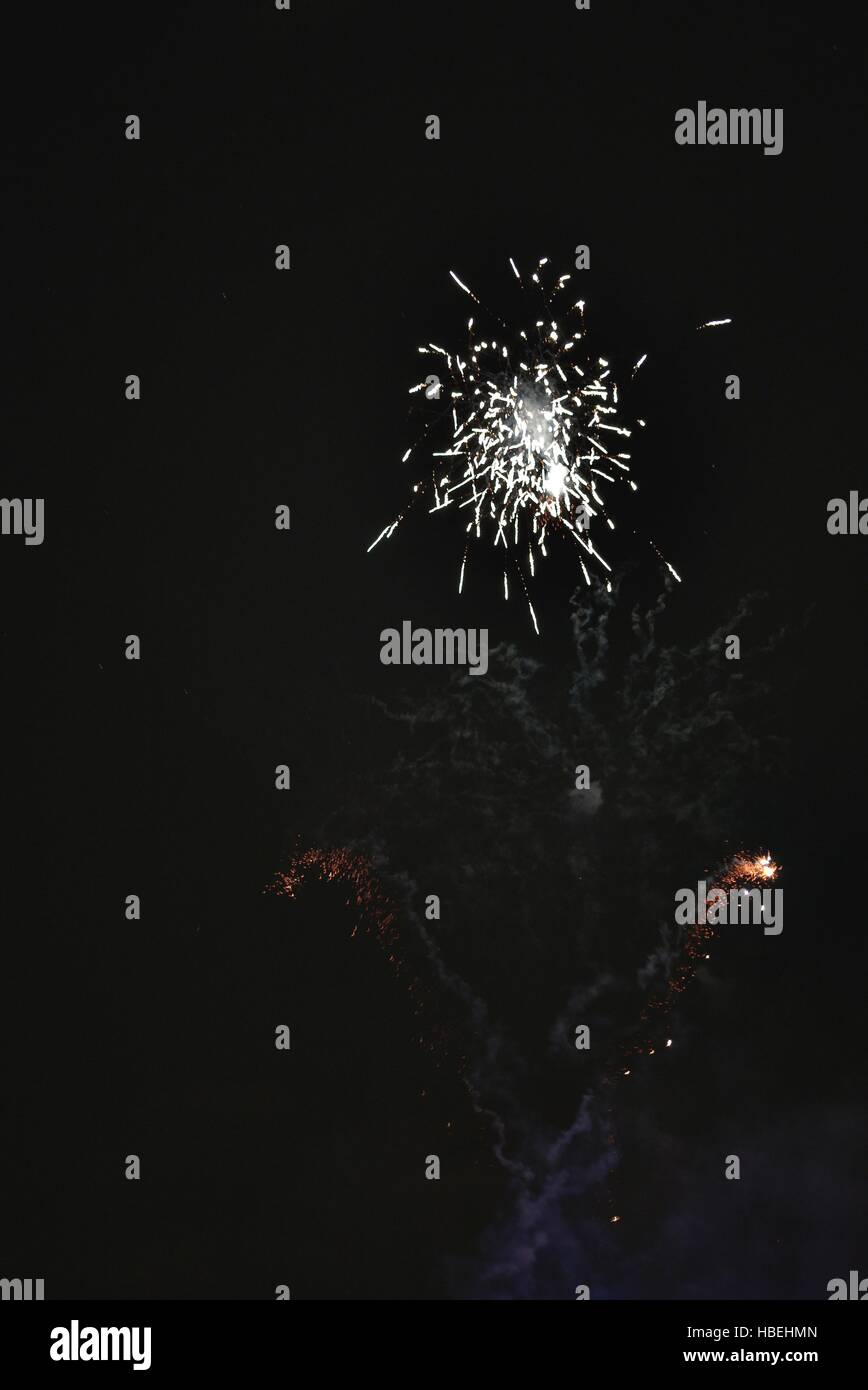 Shiny natural fireworks on dark black sky background with a little ...