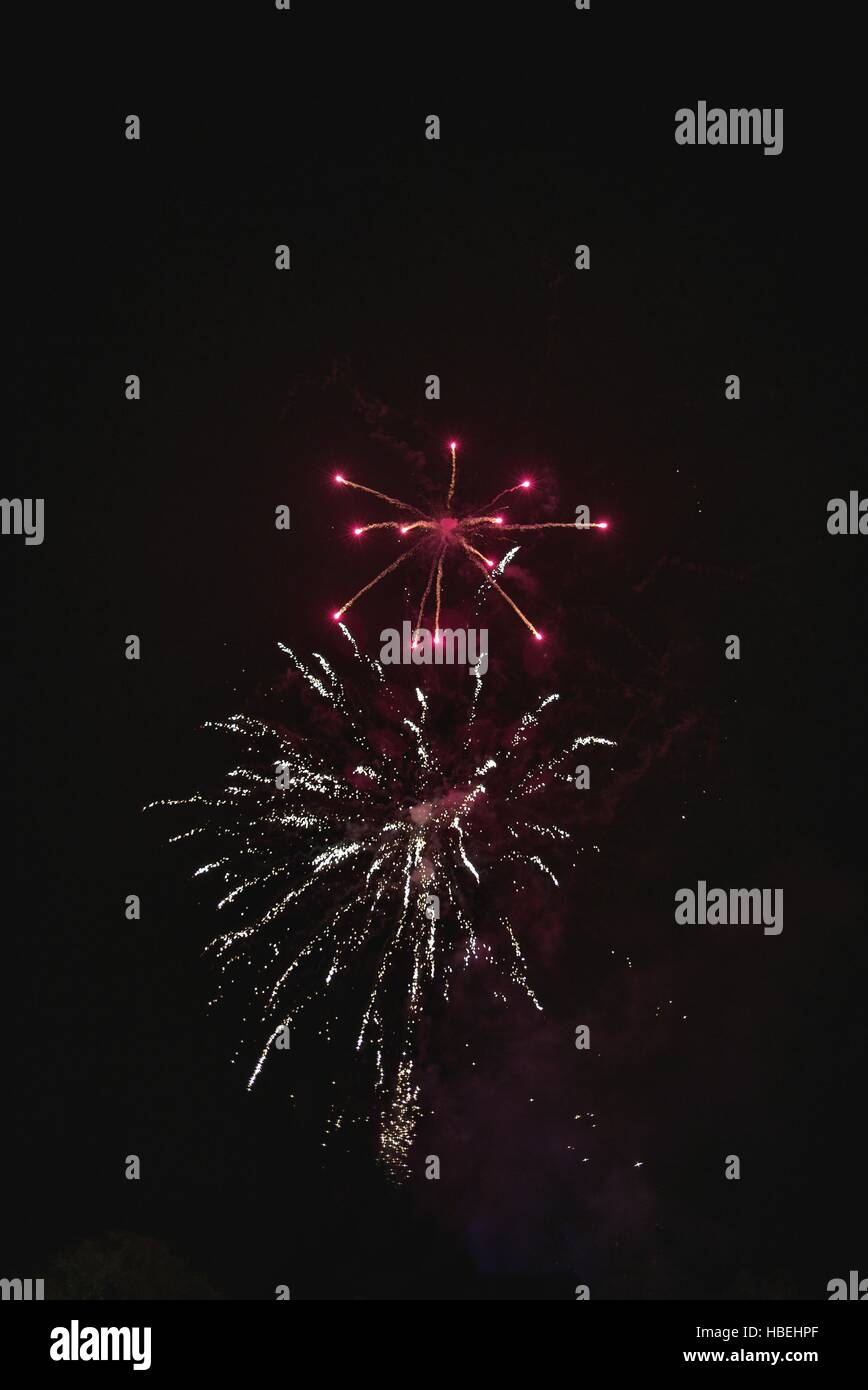 Shiny natural fireworks on dark black sky background with a little ...