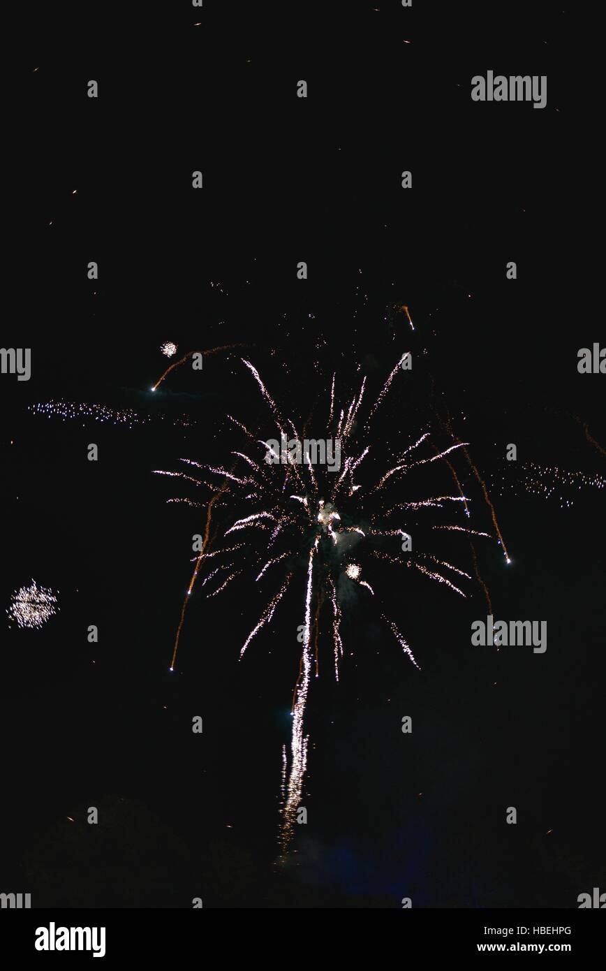 Shiny natural fireworks on dark black sky background with a little ...