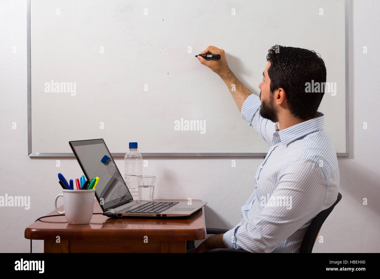 Employee writing in white board Stock Photo - Alamy