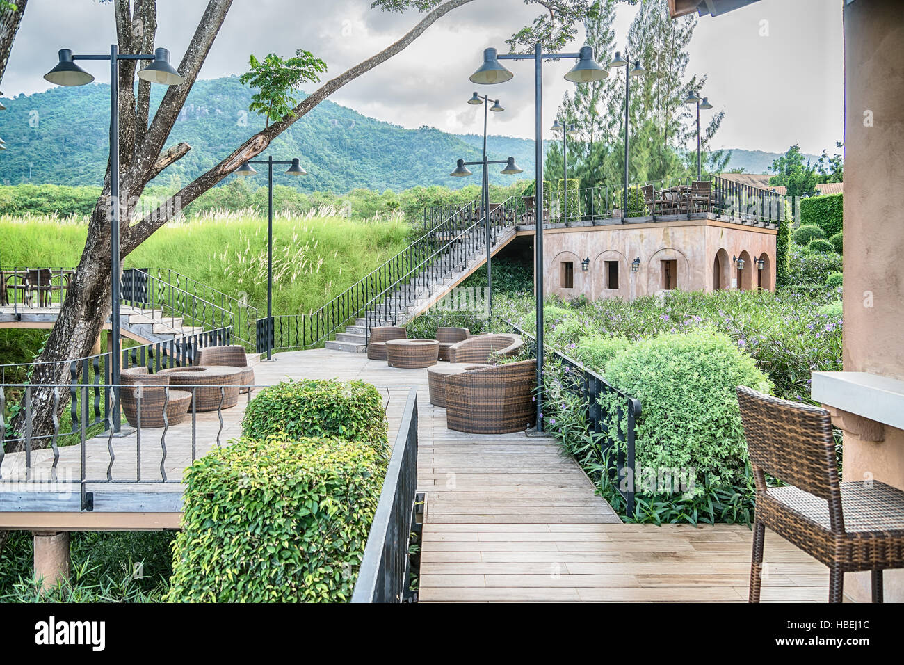 The wood table on natural outdoor of a restaurant with tree and cloudy ...