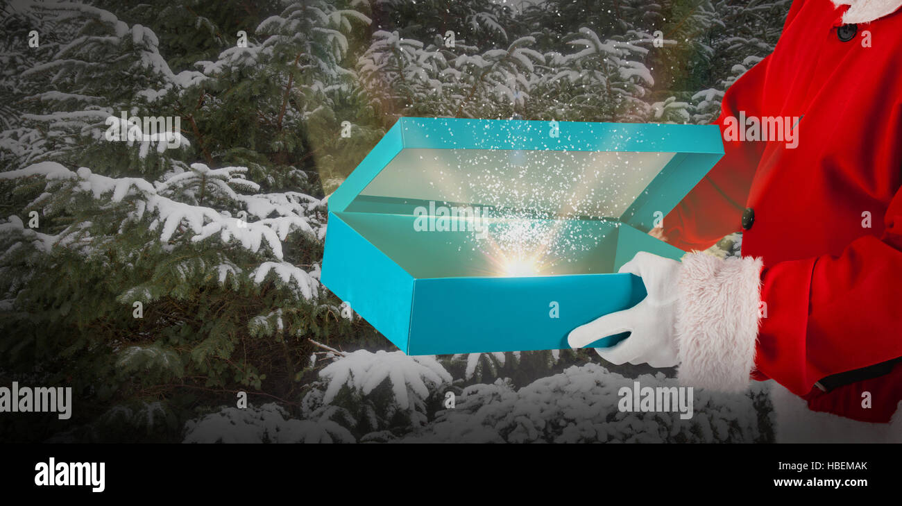 Composite image of santa claus opening gift box Stock Photo - Alamy