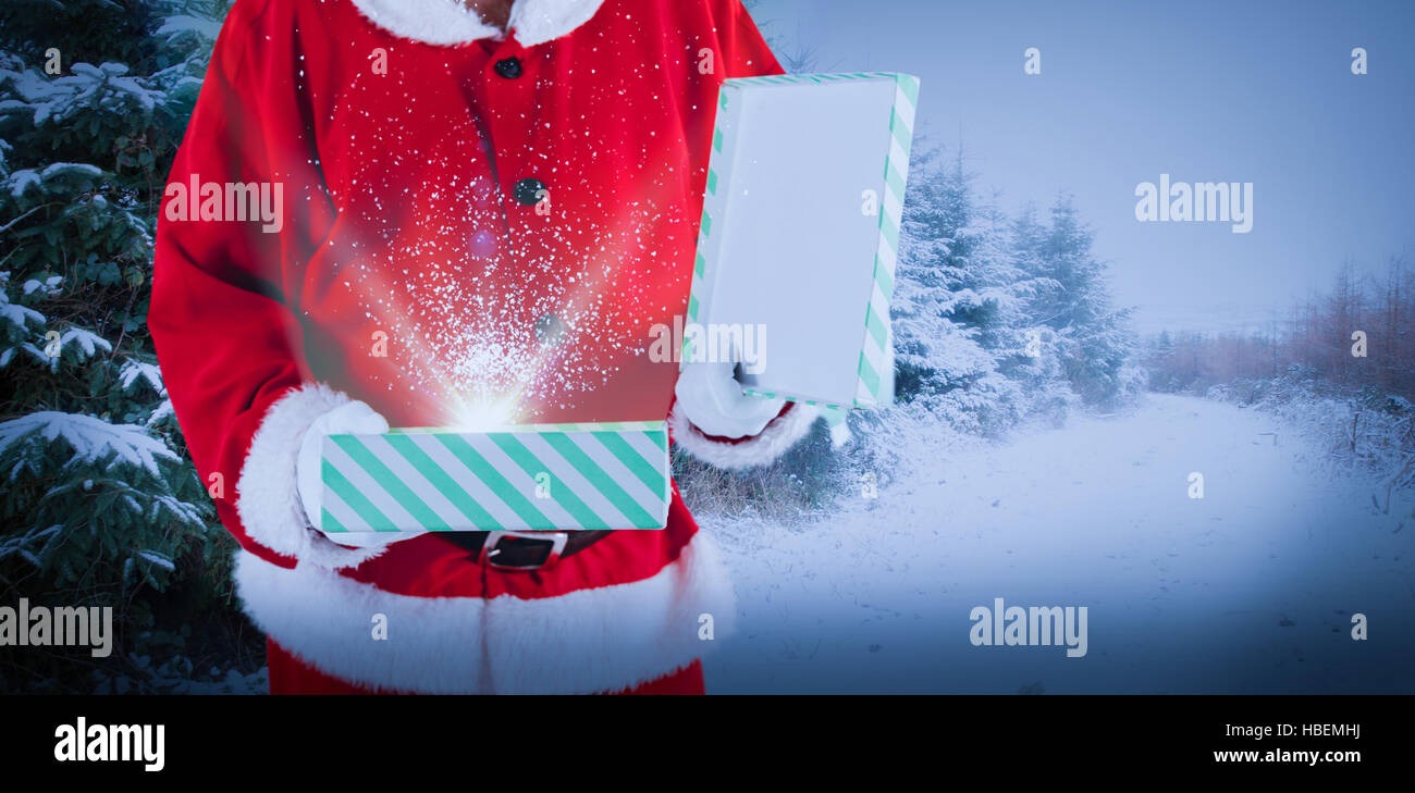 Composite image of midsection of santa claus opening gift box Stock ...