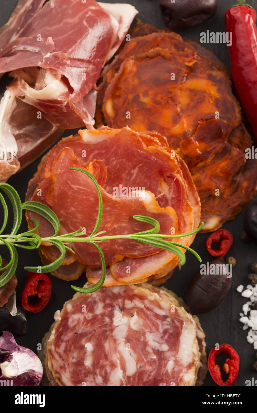 a pile of different spanish embutido, jamon, chorizo and lomo embuchado ...