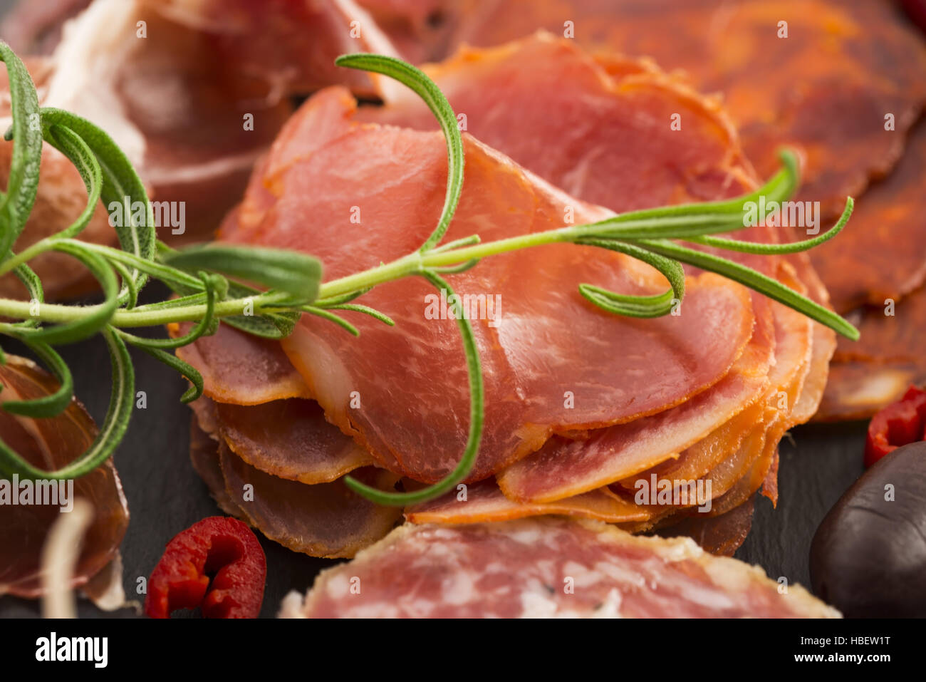 a pile of different spanish embutido, jamon, chorizo and lomo embuchado ...