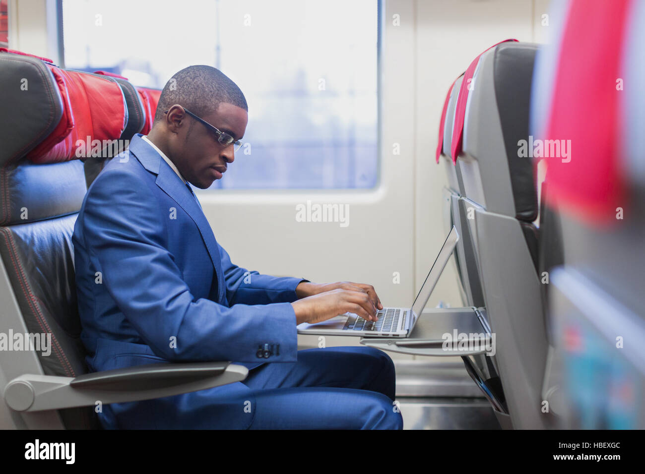 Business passenger in a train Stock Photo - Alamy