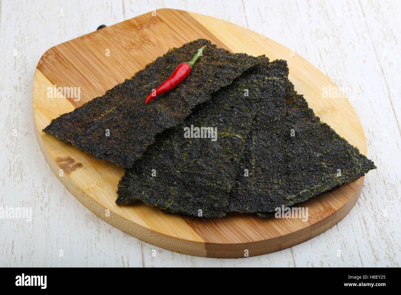 Spicy Nori seaweed sheets with pepper on wood Stock Photo - Alamy