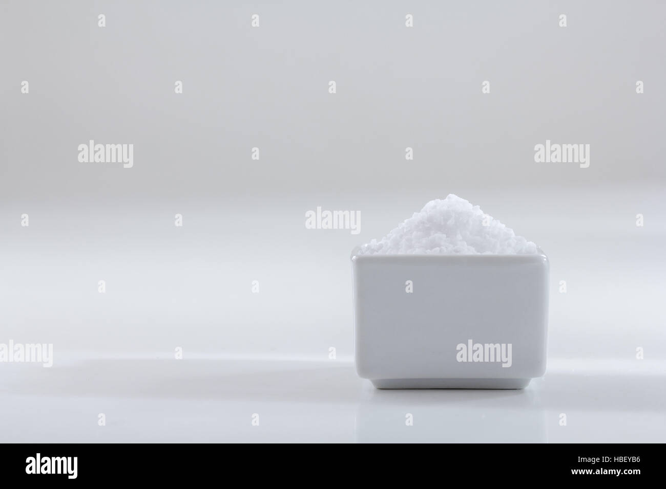 Salt in a small porcelaine cup Stock Photo - Alamy