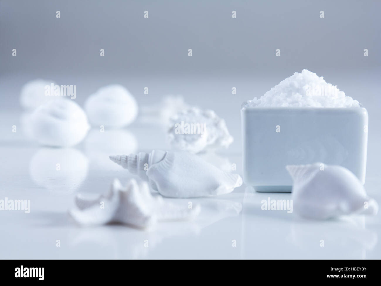 Salt in a small porcelaine cup with shells Stock Photo - Alamy