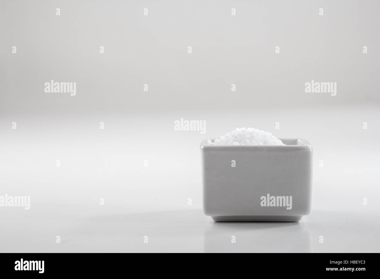 Salt in a small porcelaine cup Stock Photo - Alamy