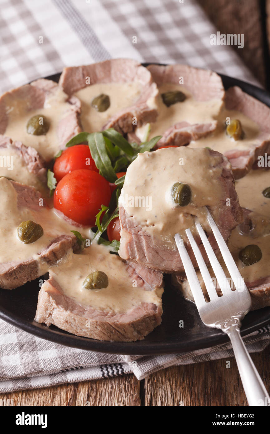 Italian beef with tuna sauce on a plate close-up. vertical Stock Photo ...
