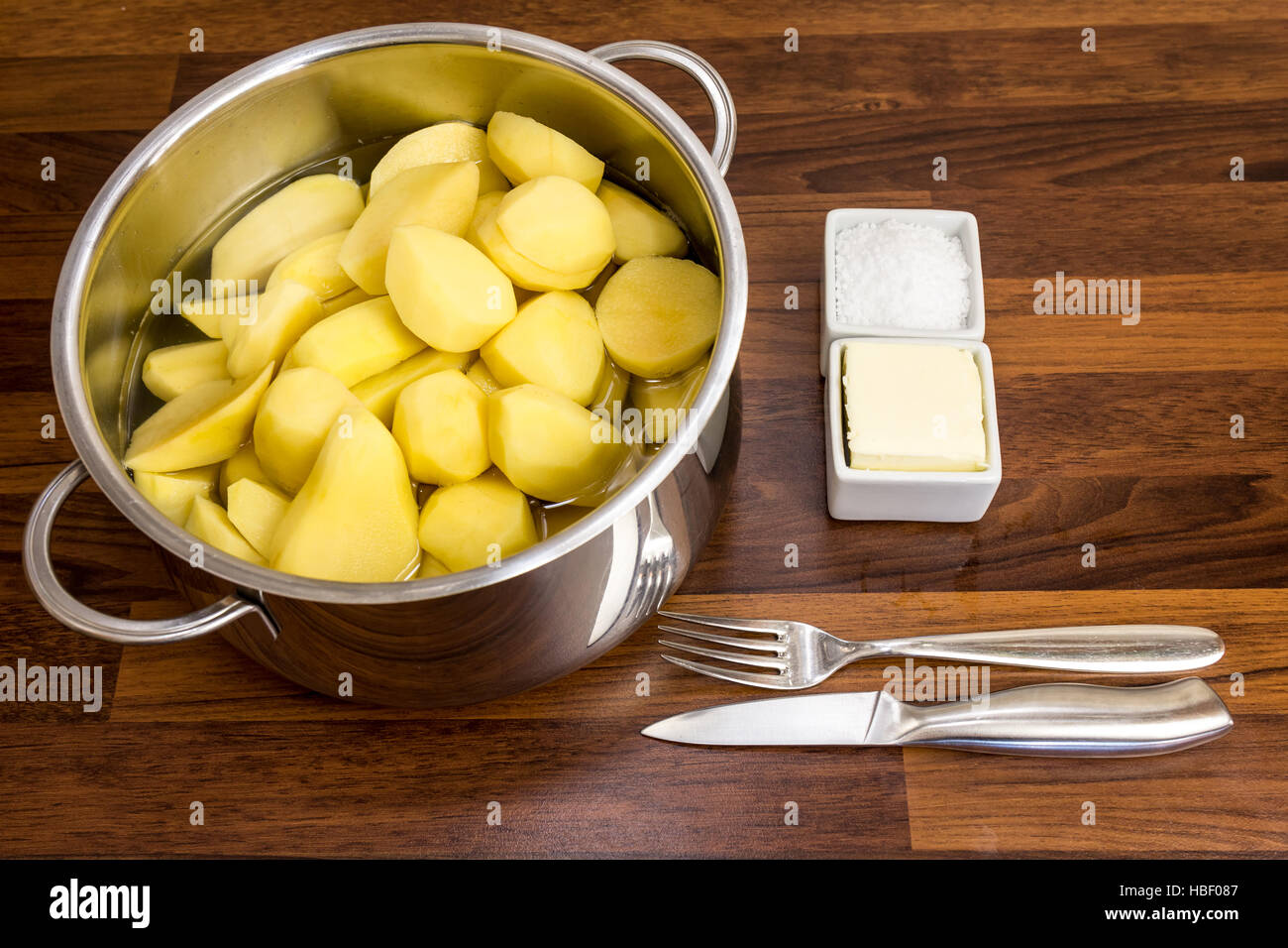 In a silver pot are peeled potatoes Stock Photo - Alamy