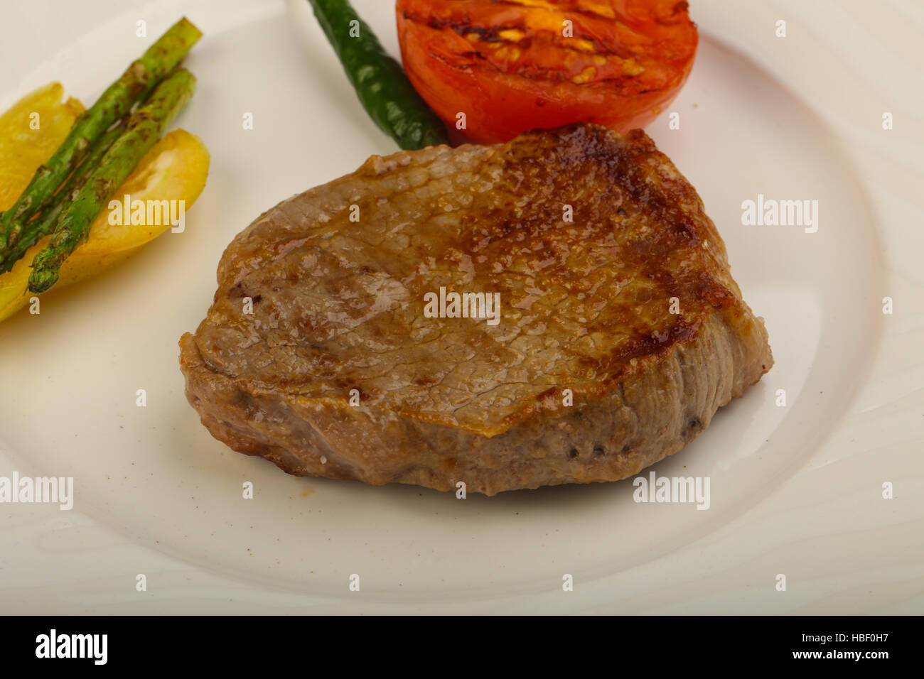 Grilled beef steak with asparagus, pepper and tomato Stock Photo - Alamy