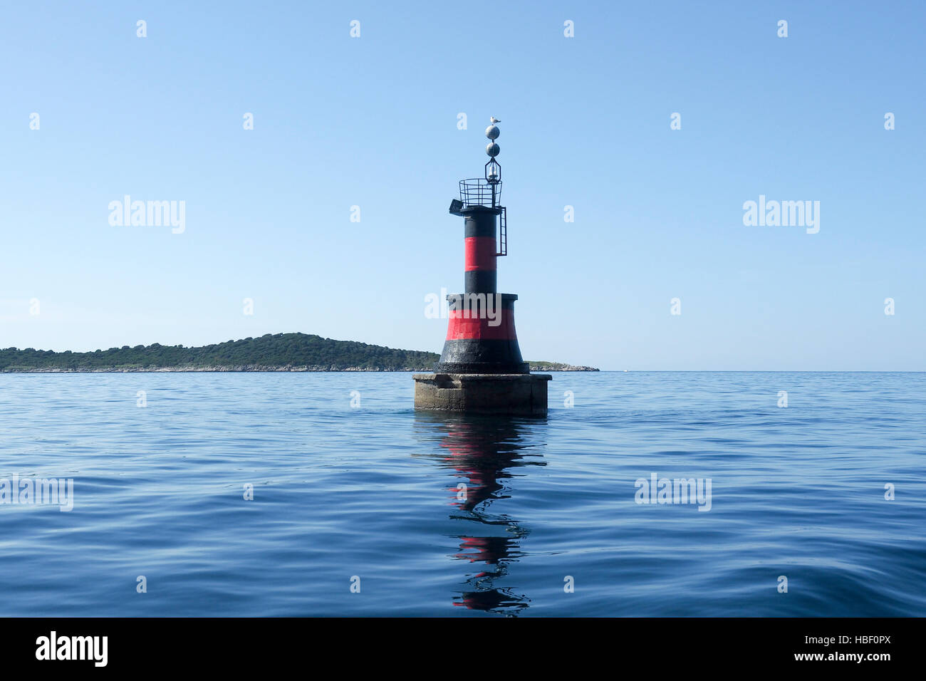 Red and Black Light Buoy at the entrance to a harbour Stock Photo - Alamy