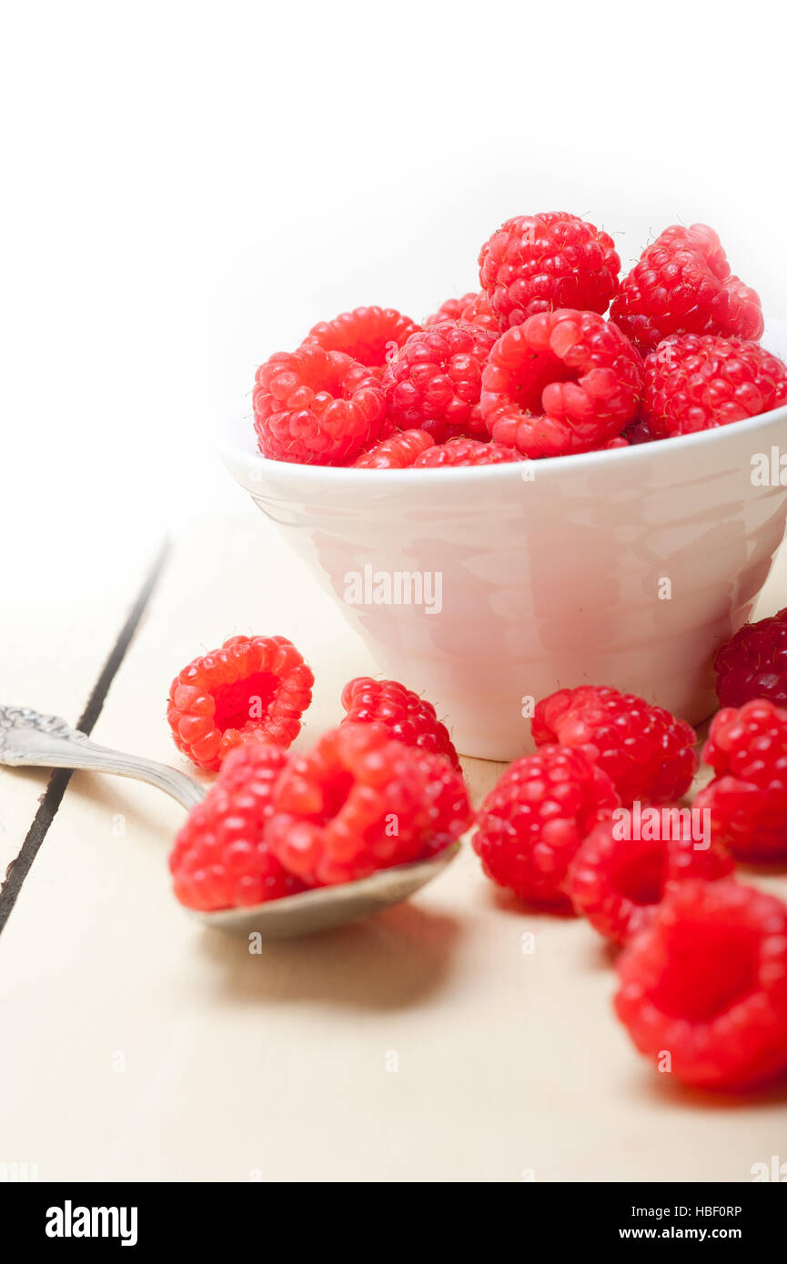 bunch of fresh raspberry on a bowl and white table Stock Photo - Alamy
