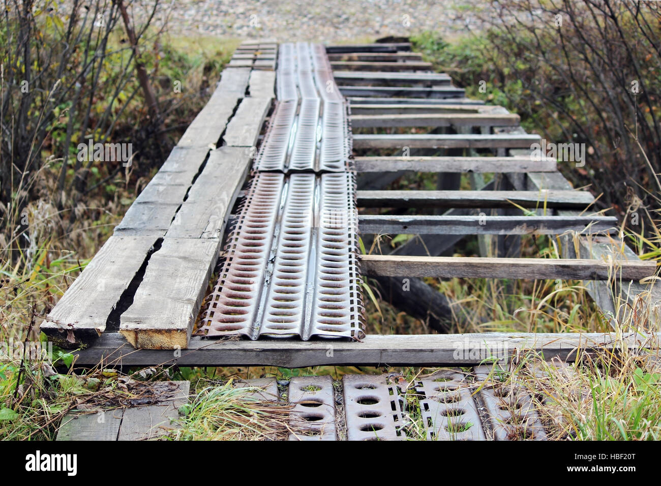 destroyed a bridge across the ditch from wooden planks and metal ...