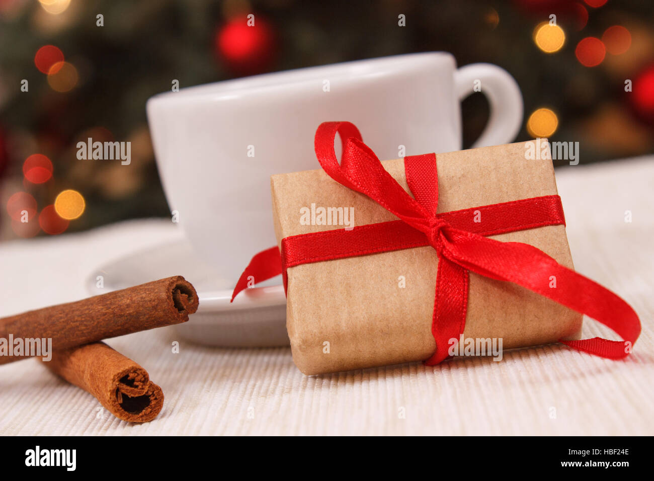 Wrapped gift with ribbons for xmas, cup of hot tea or coffee and ...