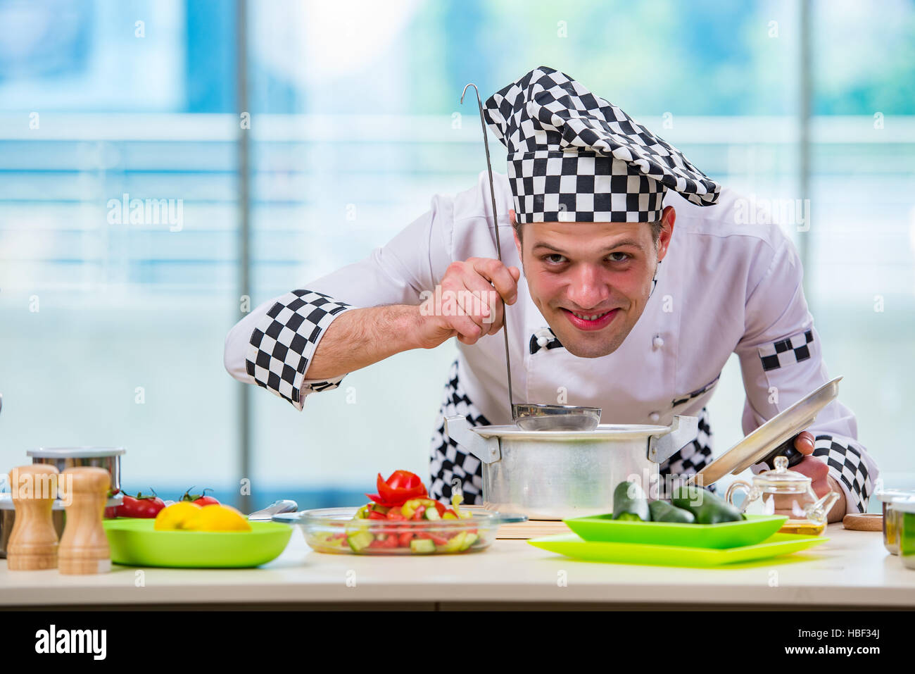 Male cook preparing food in the kitchen Stock Photo - Alamy
