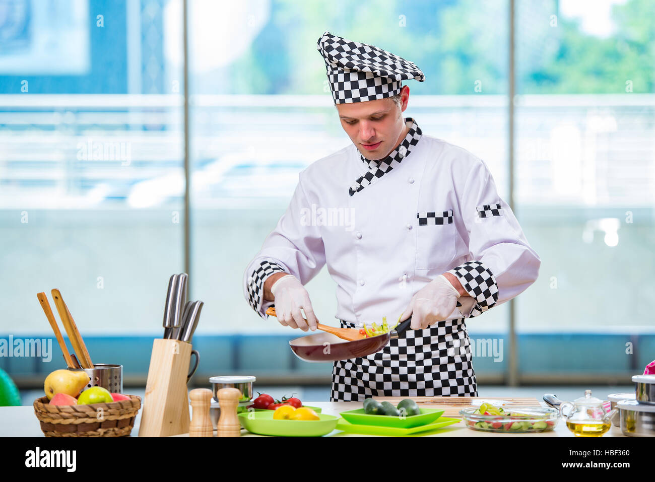 Male cook preparing food in the kitchen Stock Photo - Alamy