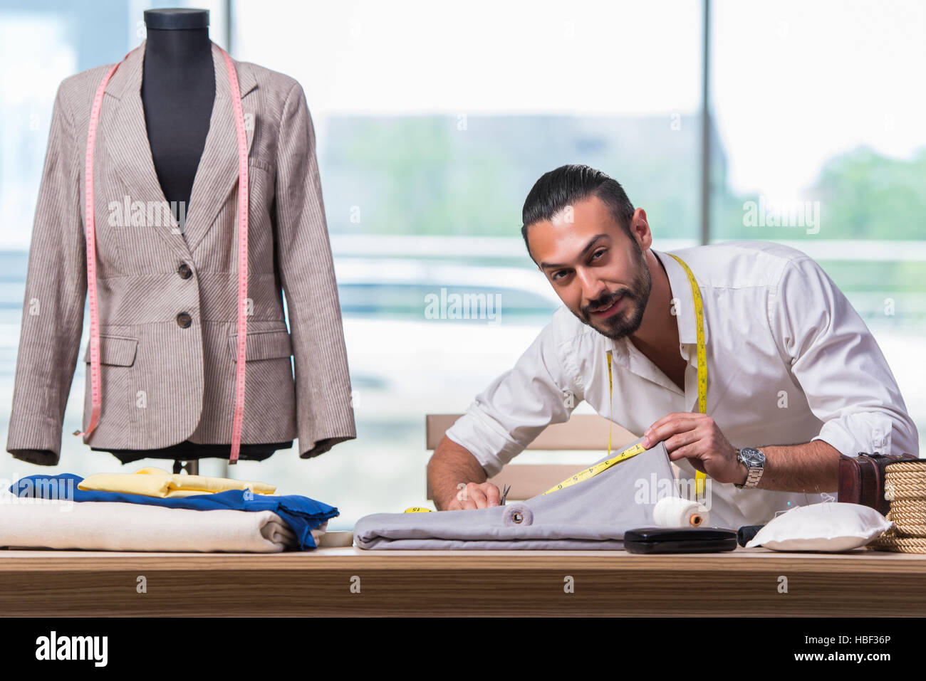 Young tailor working on new clothing design Stock Photo - Alamy